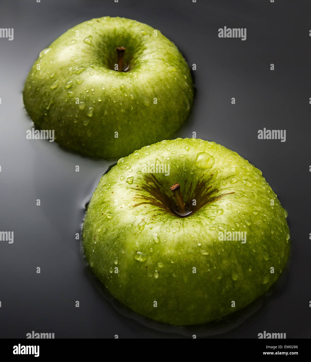 Apples over water Stock Photo - Alamy