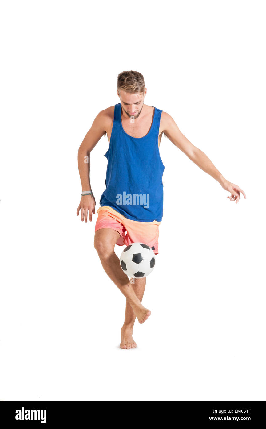 Young attractive guy playing with football on white background Stock ...