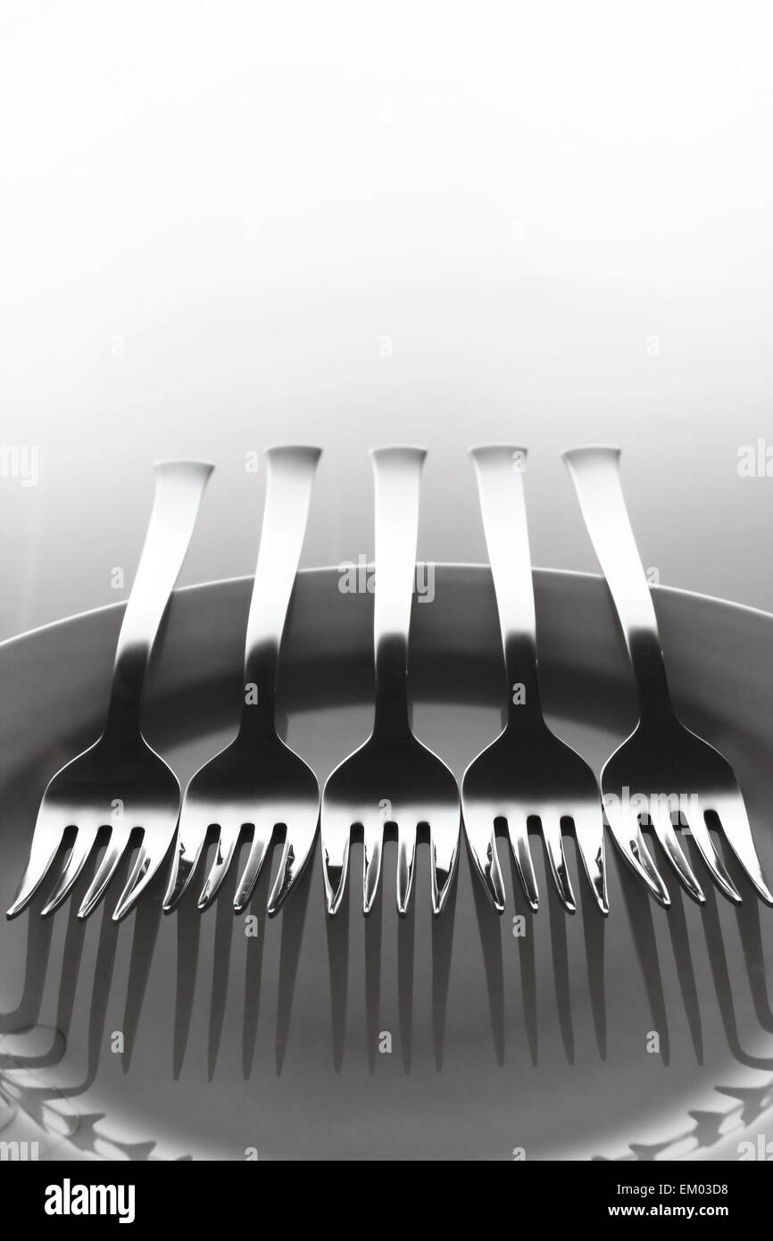 Five forks and a dish Stock Photo - Alamy