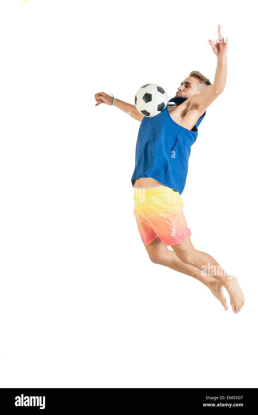 Young attractive guy playing with football on white background Stock ...