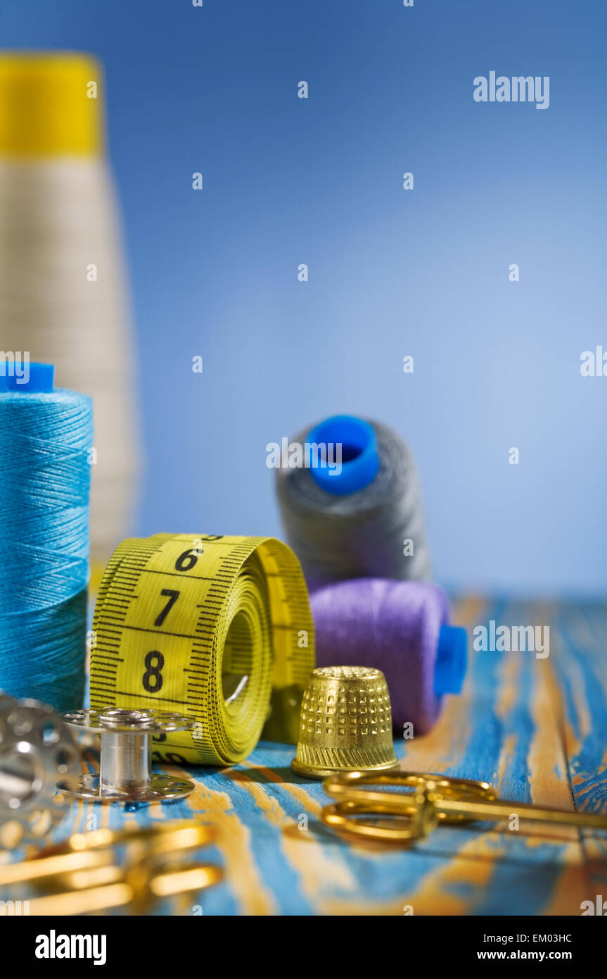 sewing items on blue background Stock Photo - Alamy