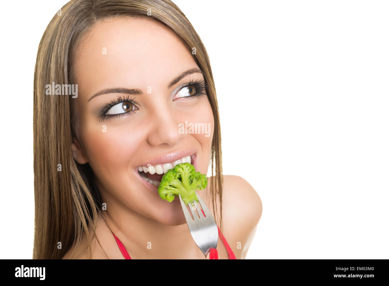 Happy young woman eating broccoli Stock Photo - Alamy