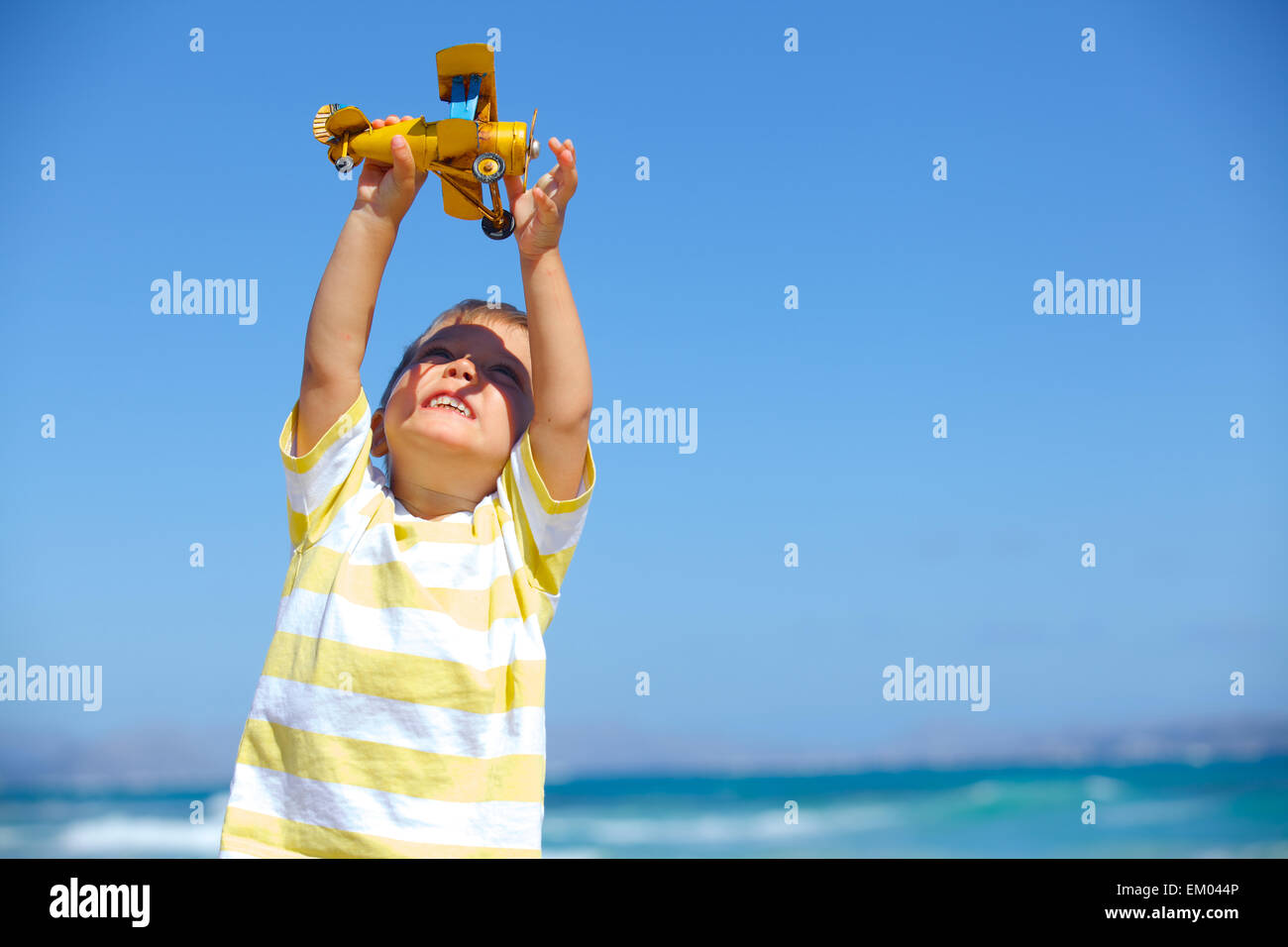 Boy playing with a toy airplane Stock Photo - Alamy