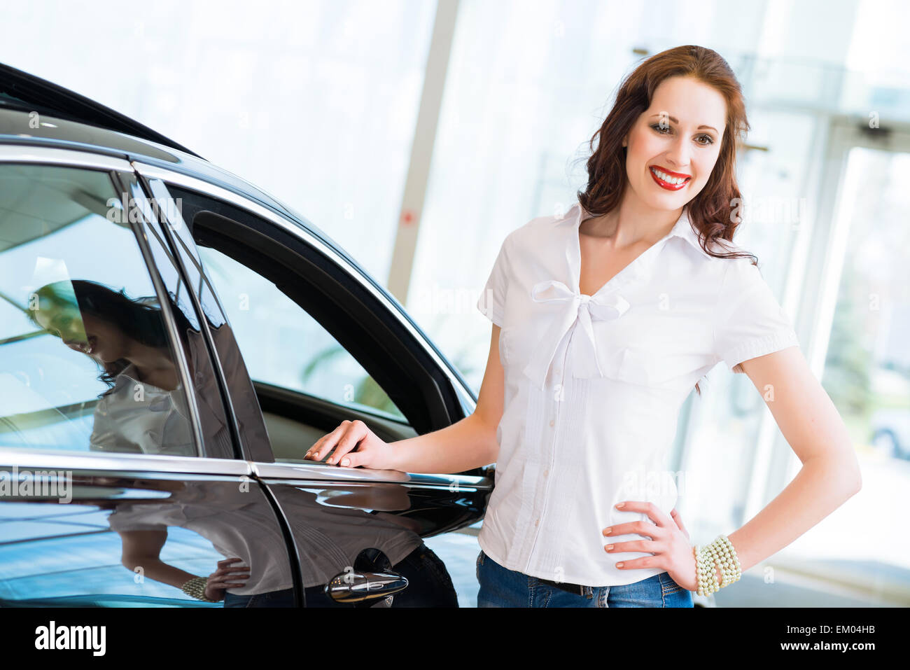 young woman standing near a car Stock Photo - Alamy