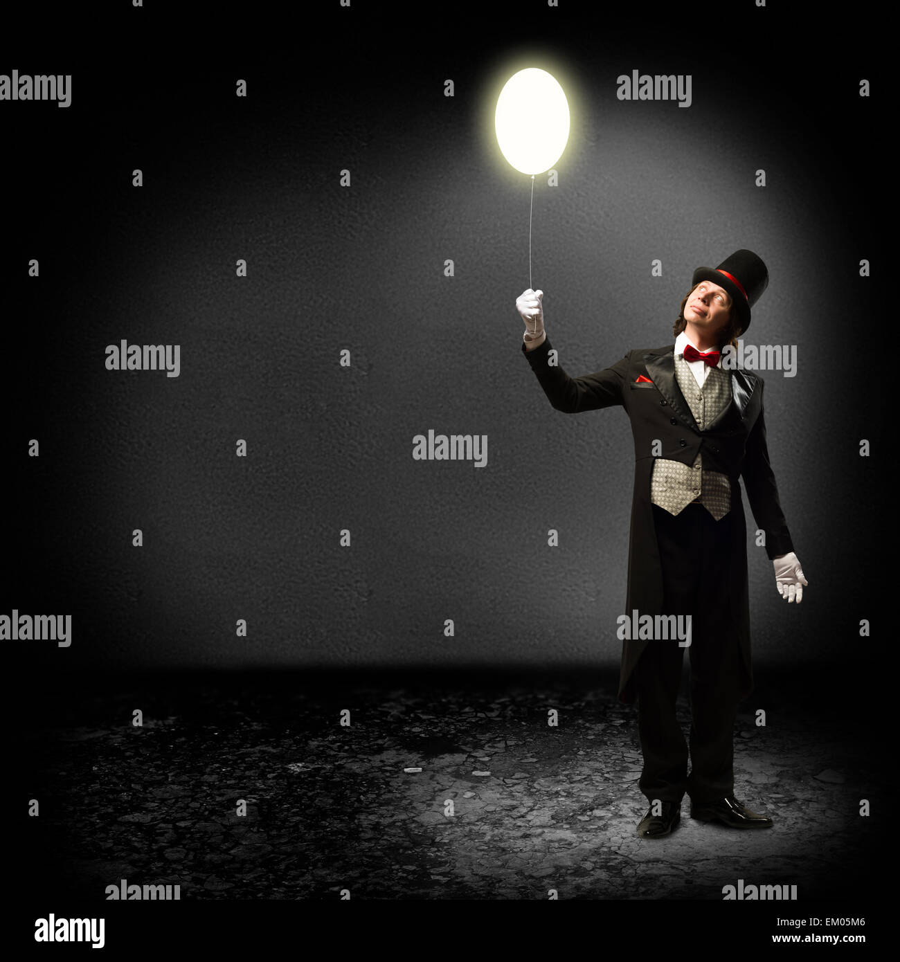 magician holding a glowing balloon Stock Photo - Alamy