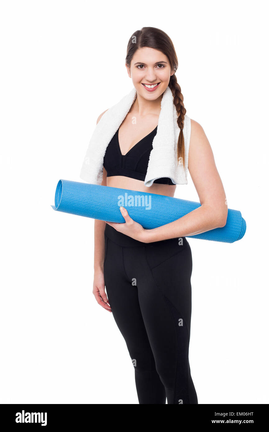Pretty gym woman holding blue mat Stock Photo - Alamy