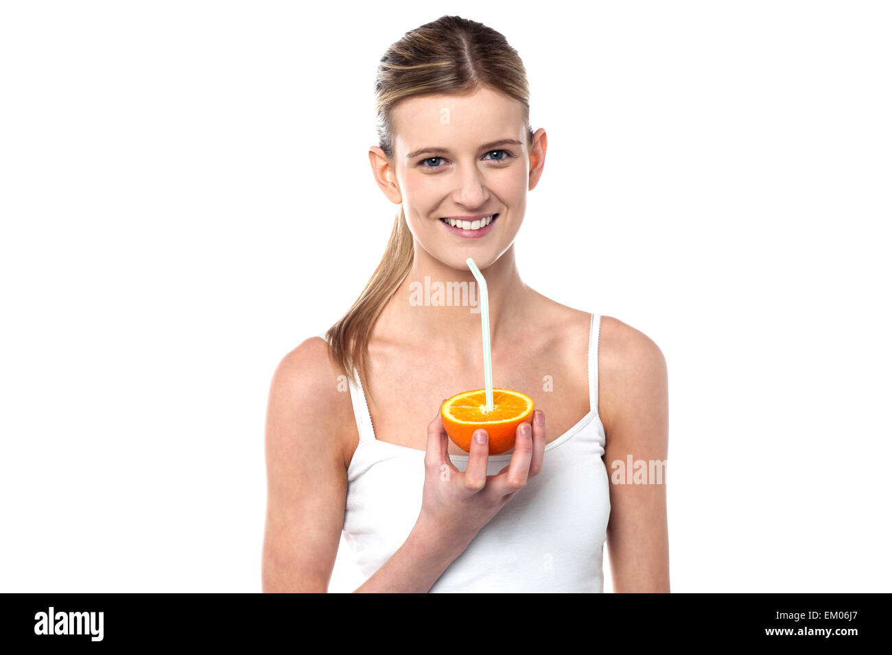 Girl sipping orange juice through straw Stock Photo - Alamy