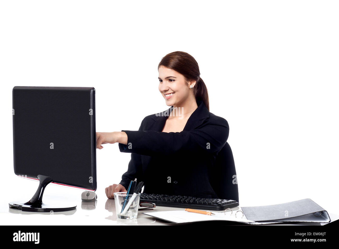 Female staff pointing at monitor screen Stock Photo - Alamy
