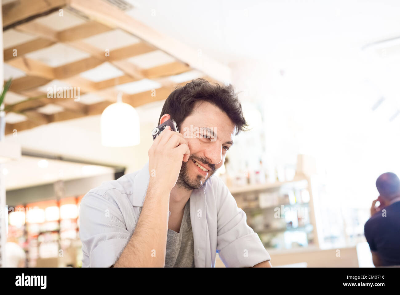 man at the bar on the phone Stock Photo - Alamy
