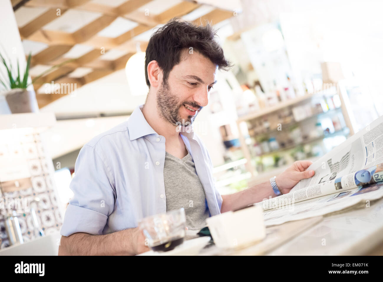 man at the bar reading newspaper Stock Photo - Alamy