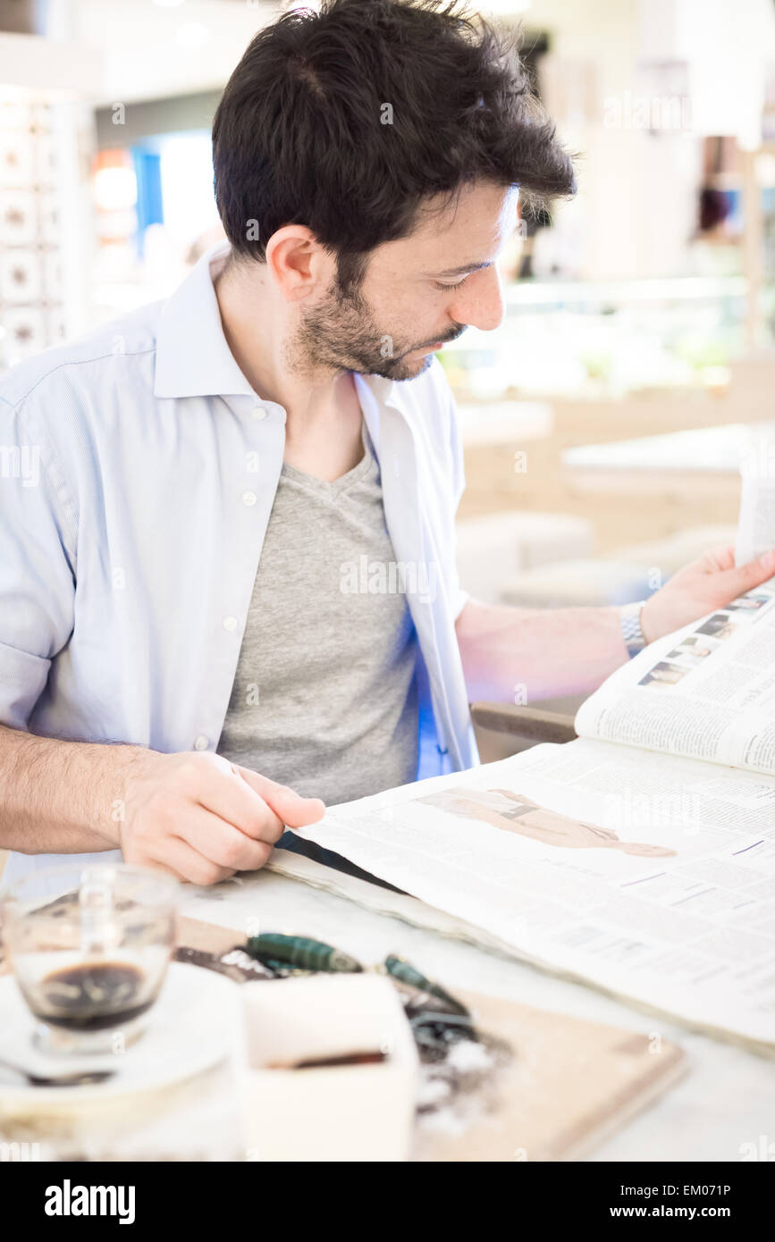 man at the bar reading newspaper Stock Photo - Alamy