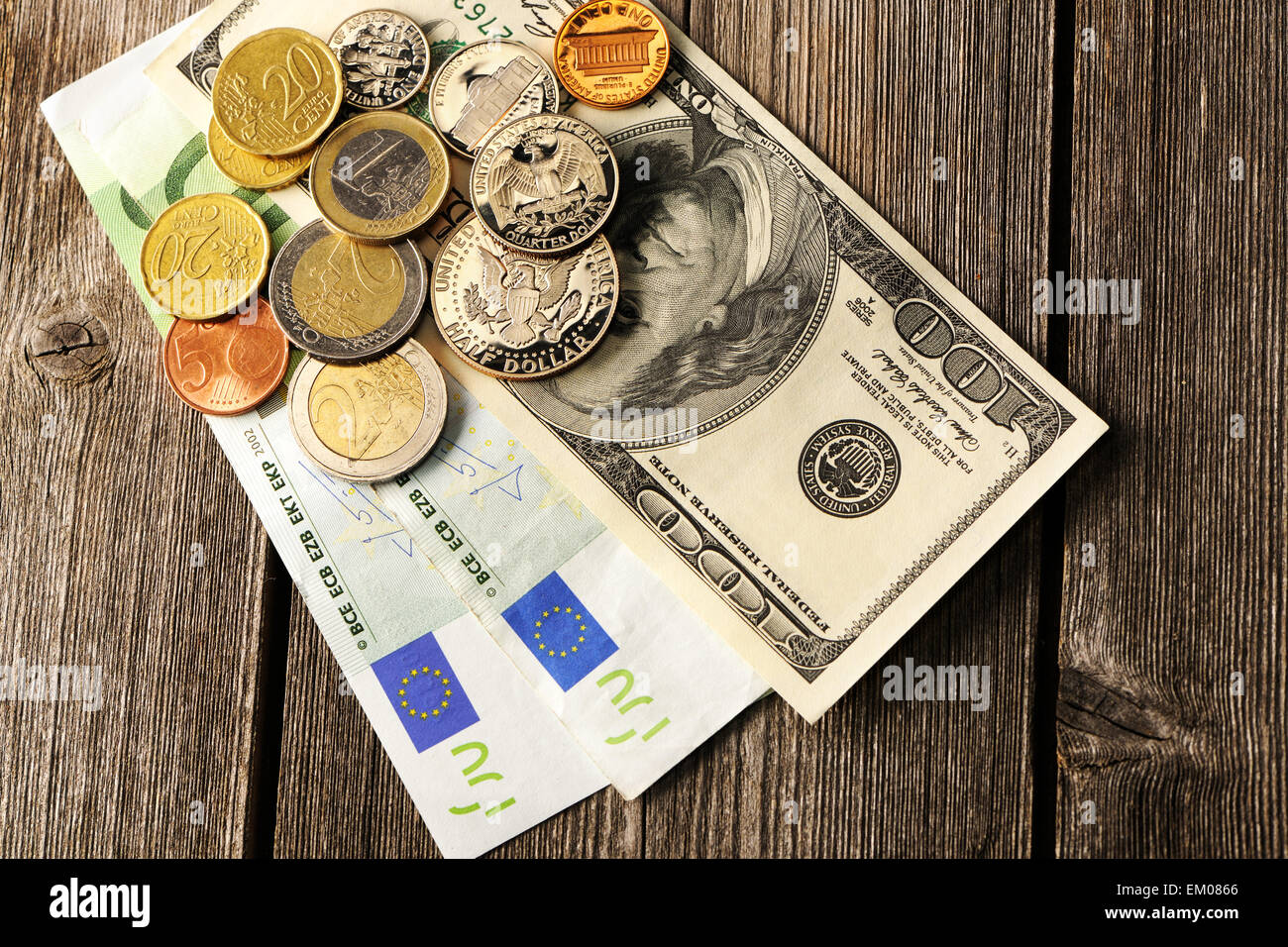 US and euro money over wooden background Stock Photo - Alamy