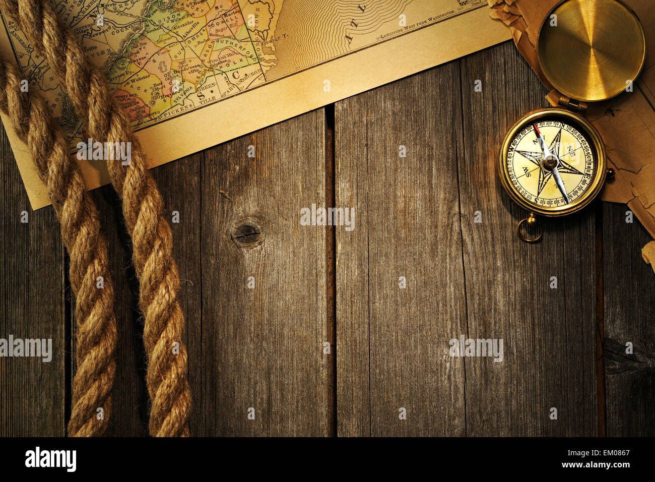 Antique compass and rope over old map Stock Photo - Alamy