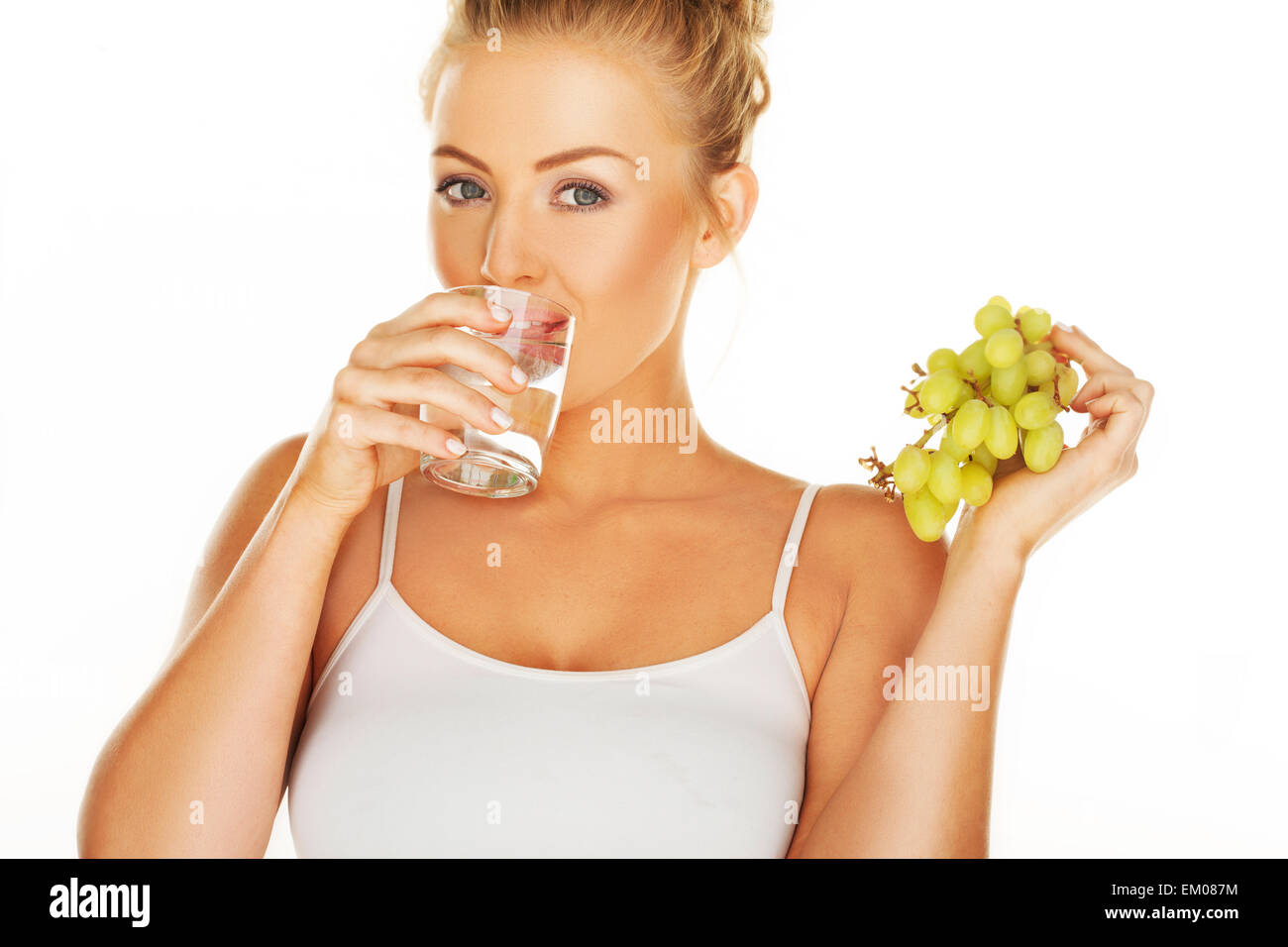 Woman drinking water and eating grapes Stock Photo - Alamy