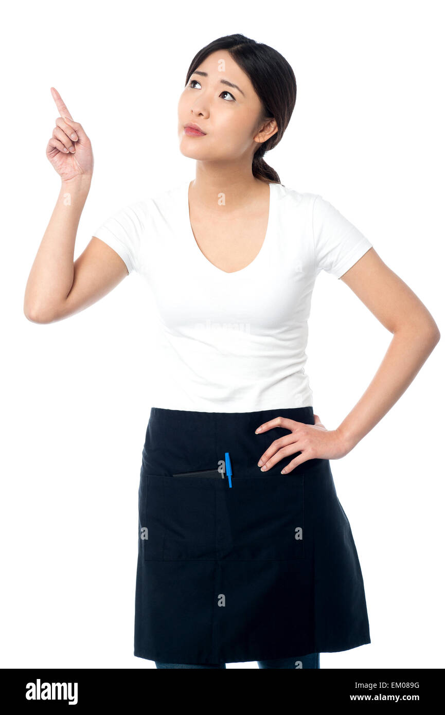 Asian waitress pointing and looking away Stock Photo - Alamy
