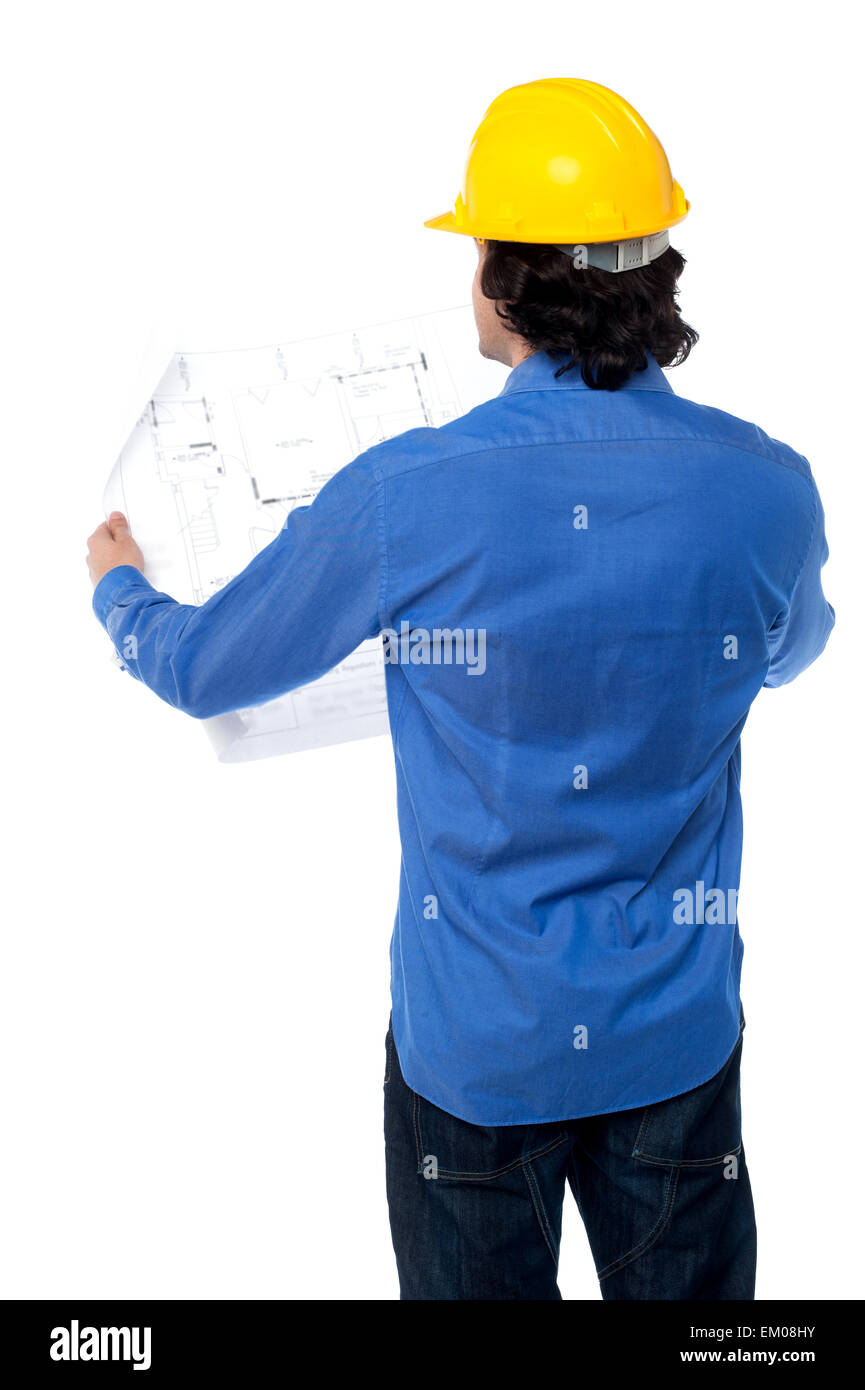 Construction worker with blueprint plan Stock Photo - Alamy