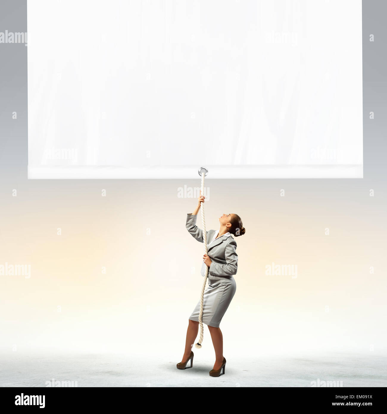 Businesswoman pulling banner Stock Photo - Alamy