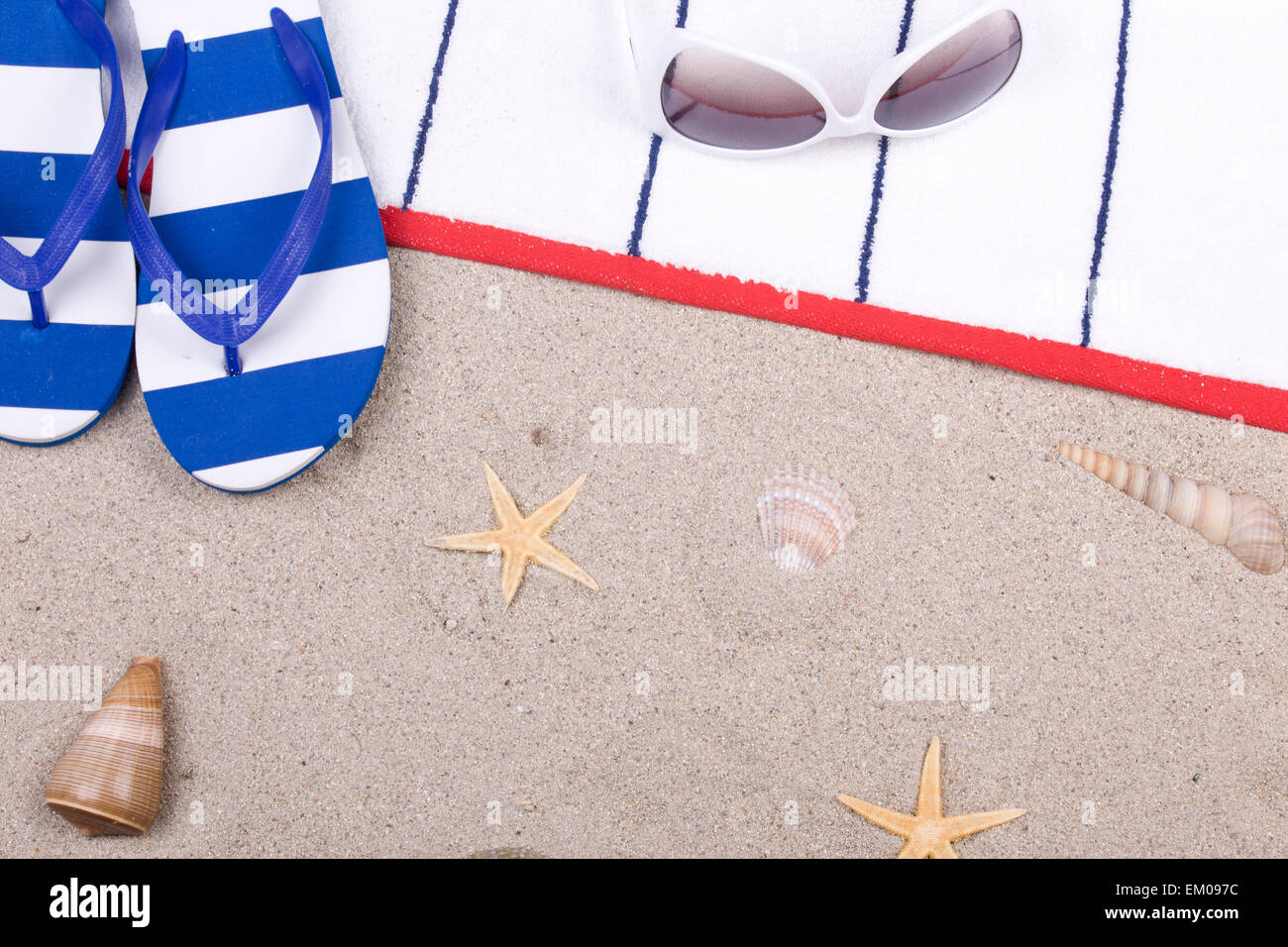 beach items on a towel and sand Stock Photo - Alamy