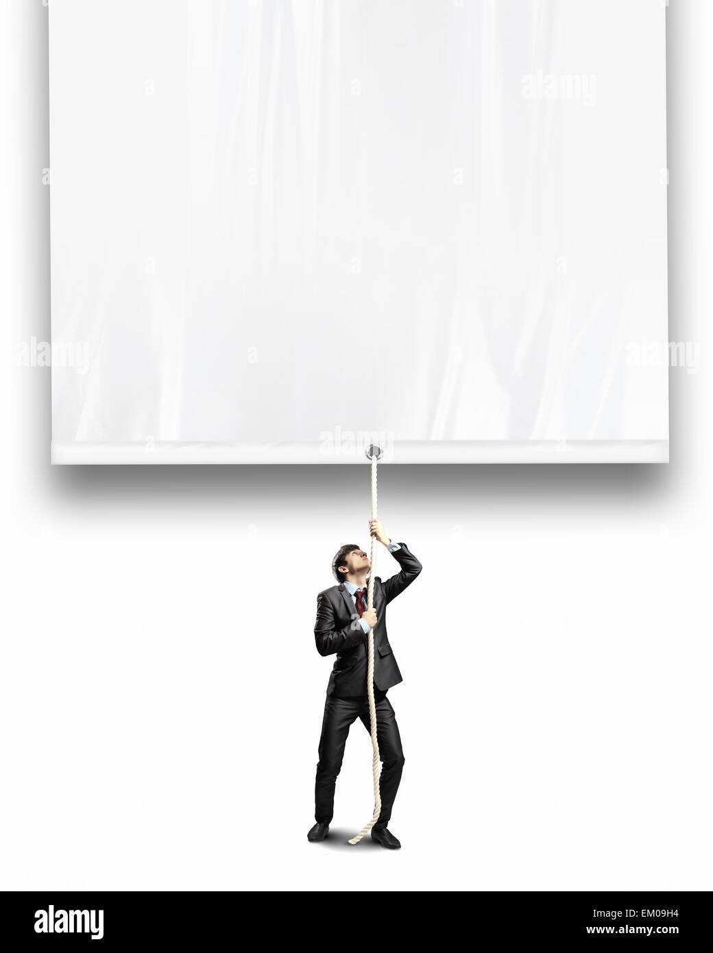 Businessman pulling banner Stock Photo - Alamy