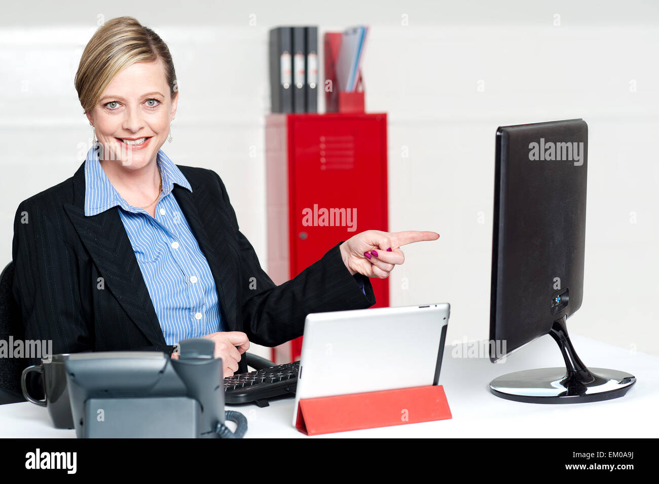 Female executive pointing at computer screen Stock Photo - Alamy