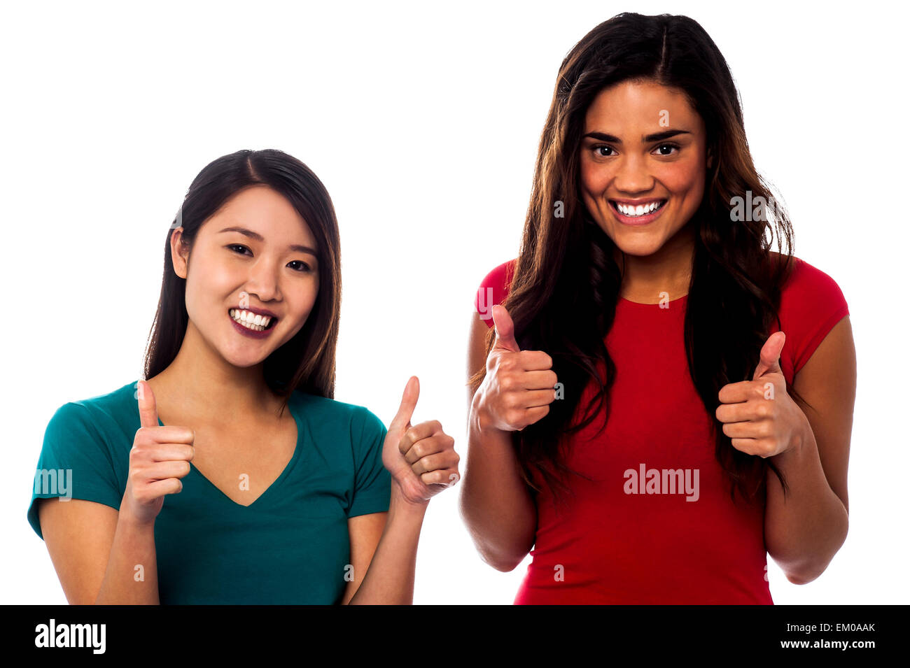 Two girls cheering up with thumbs up Stock Photo - Alamy