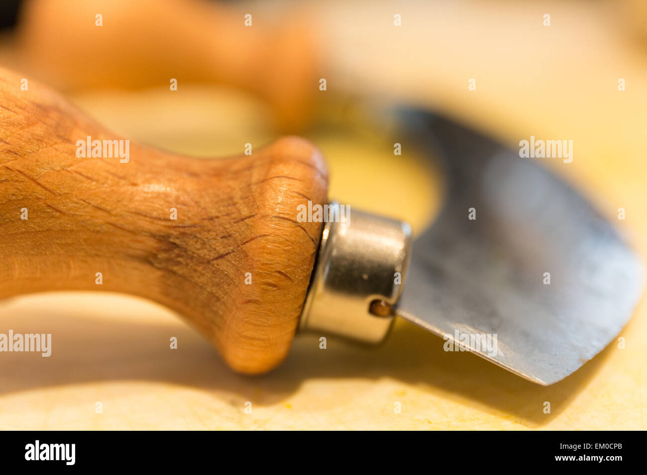 Wooden circular cheese cutting knife on a wooden cutting board Stock ...