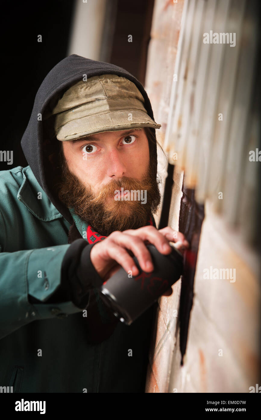 Spray painting gang member hi-res stock photography and images - Alamy