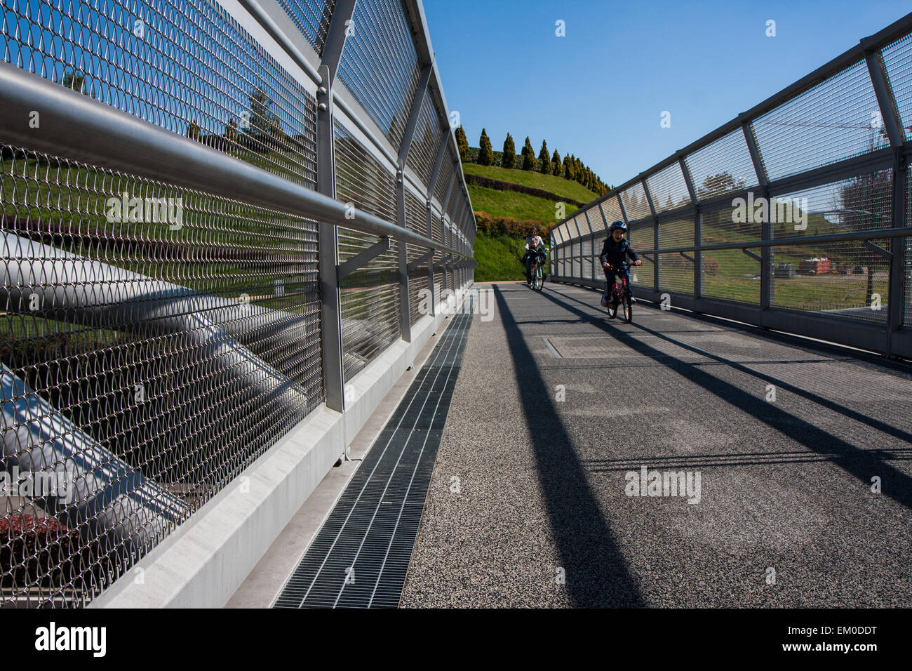 Modern steel cycle bridge that connects the city park Stock Photo - Alamy