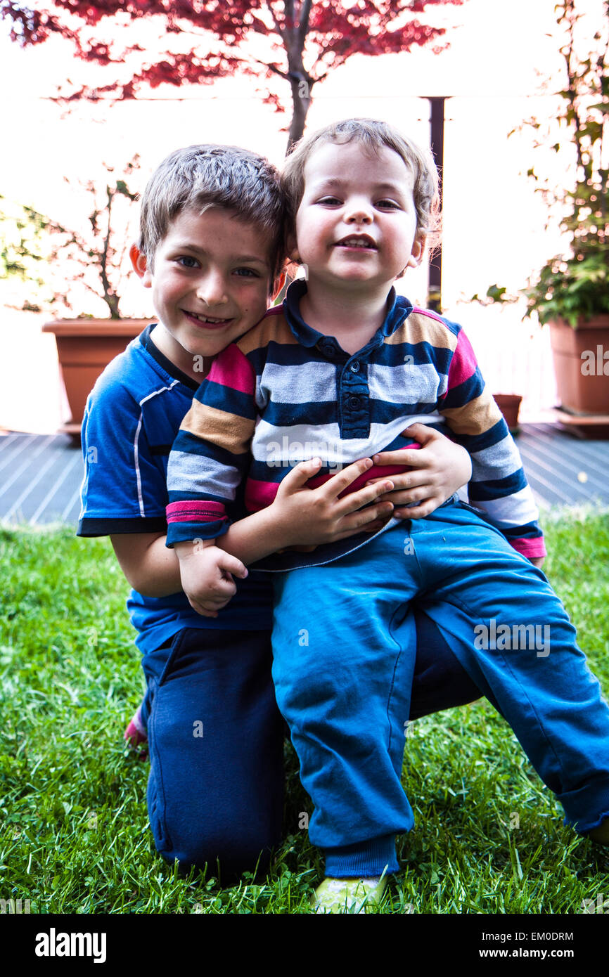 Happy kids playing on slide hi-res stock photography and images - Alamy