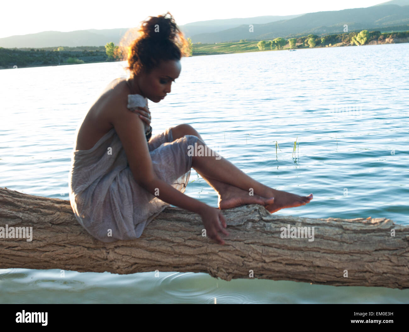 Beautiful pensive woman backlit by the sun Stock Photo - Alamy