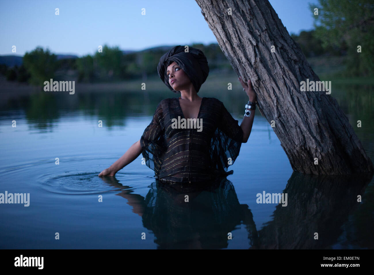 Beautiful woman wading in water Stock Photo - Alamy