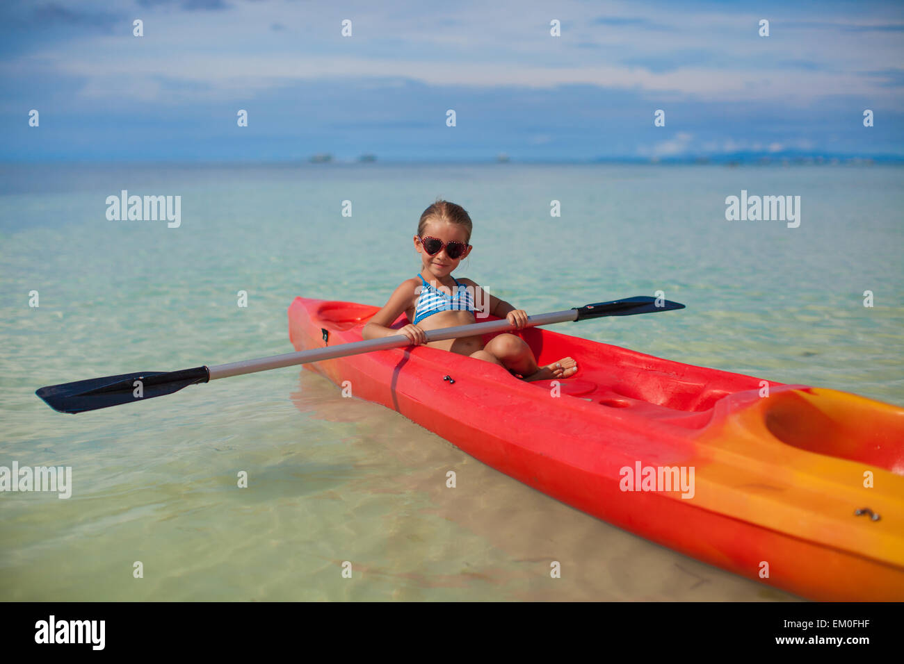 brave little cute girl floating in a kayak on the high seas Stock Photo ...