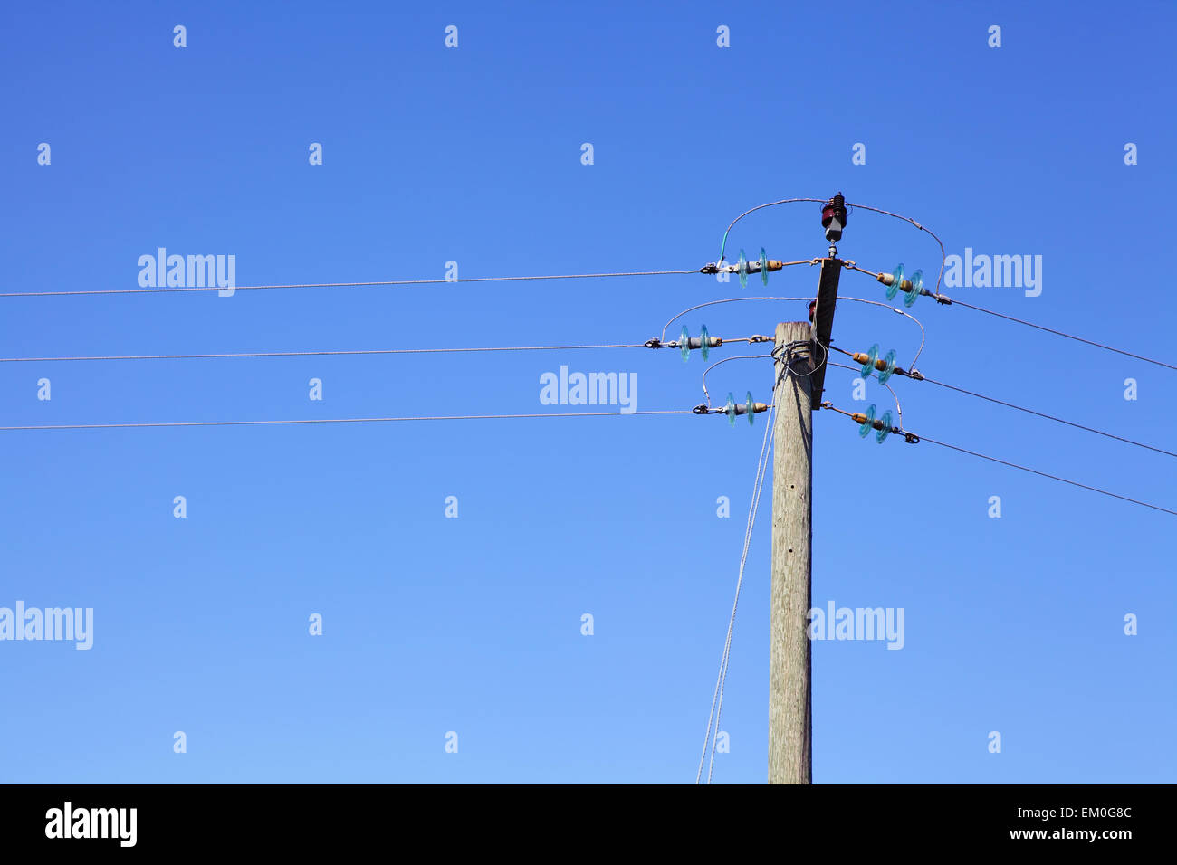 Powerline under blue sky Stock Photo - Alamy