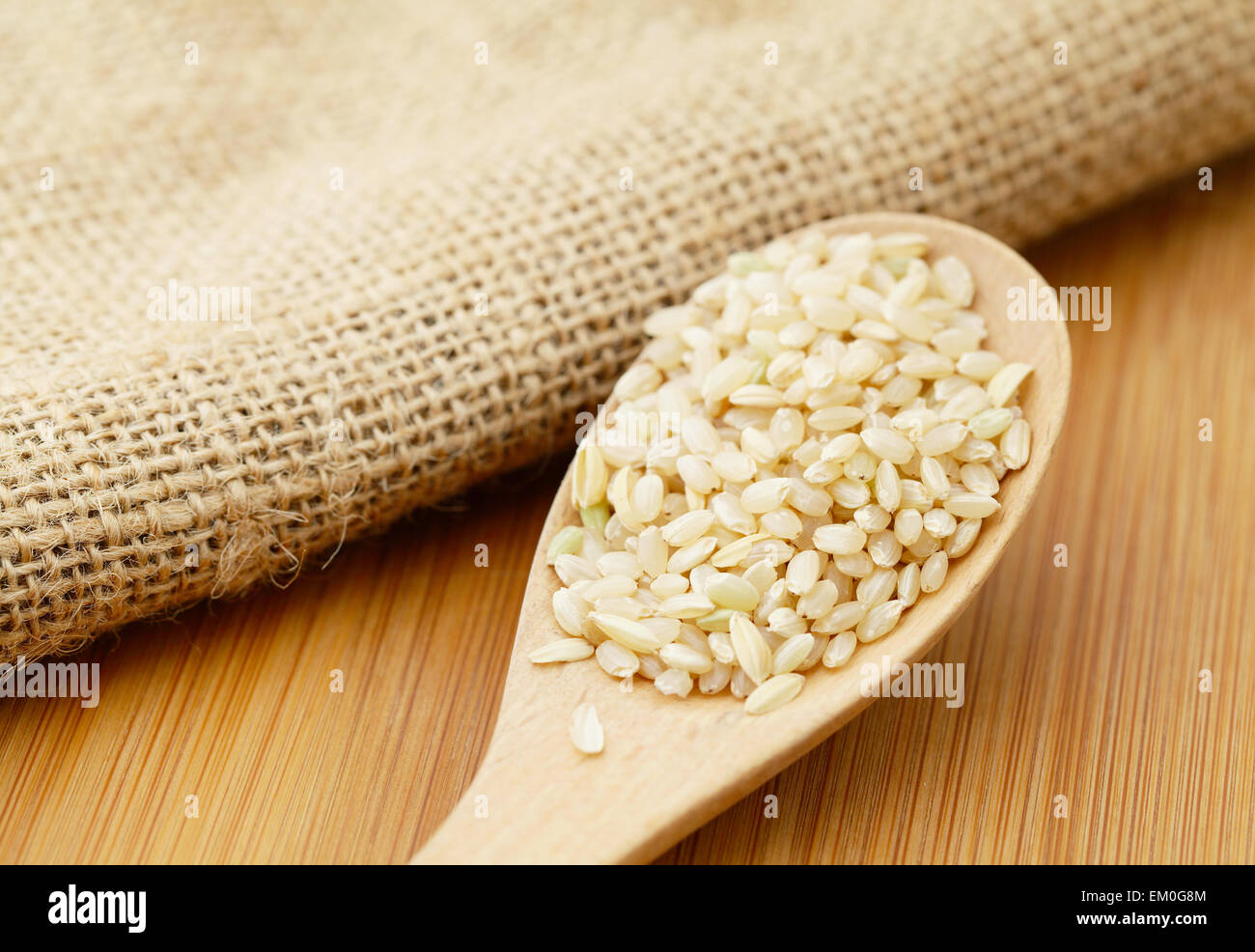 Uncooked rice on spoon Stock Photo - Alamy