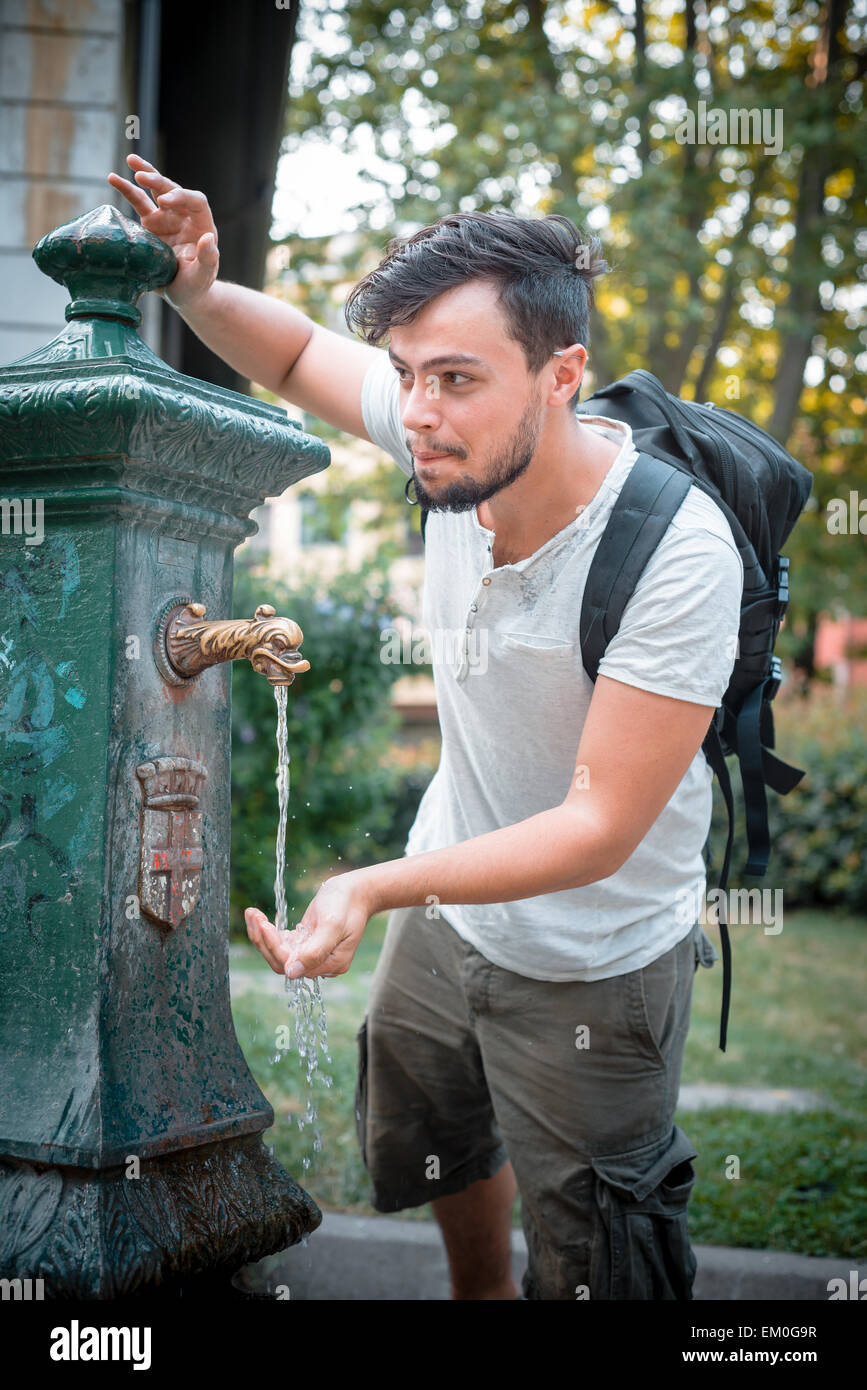 stylish man refreshing at the fountain Stock Photo - Alamy