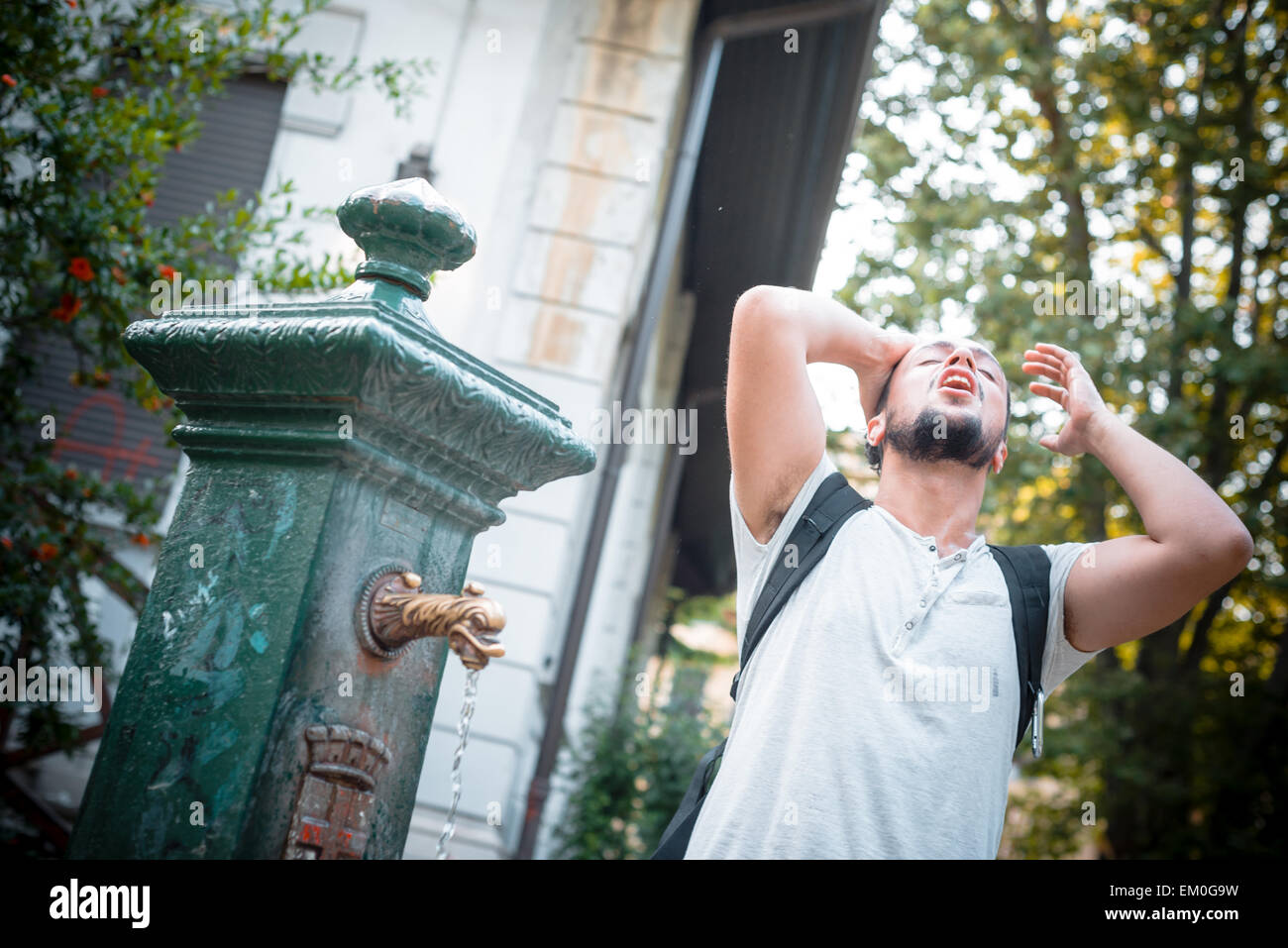 stylish man refreshing at the fountain Stock Photo - Alamy