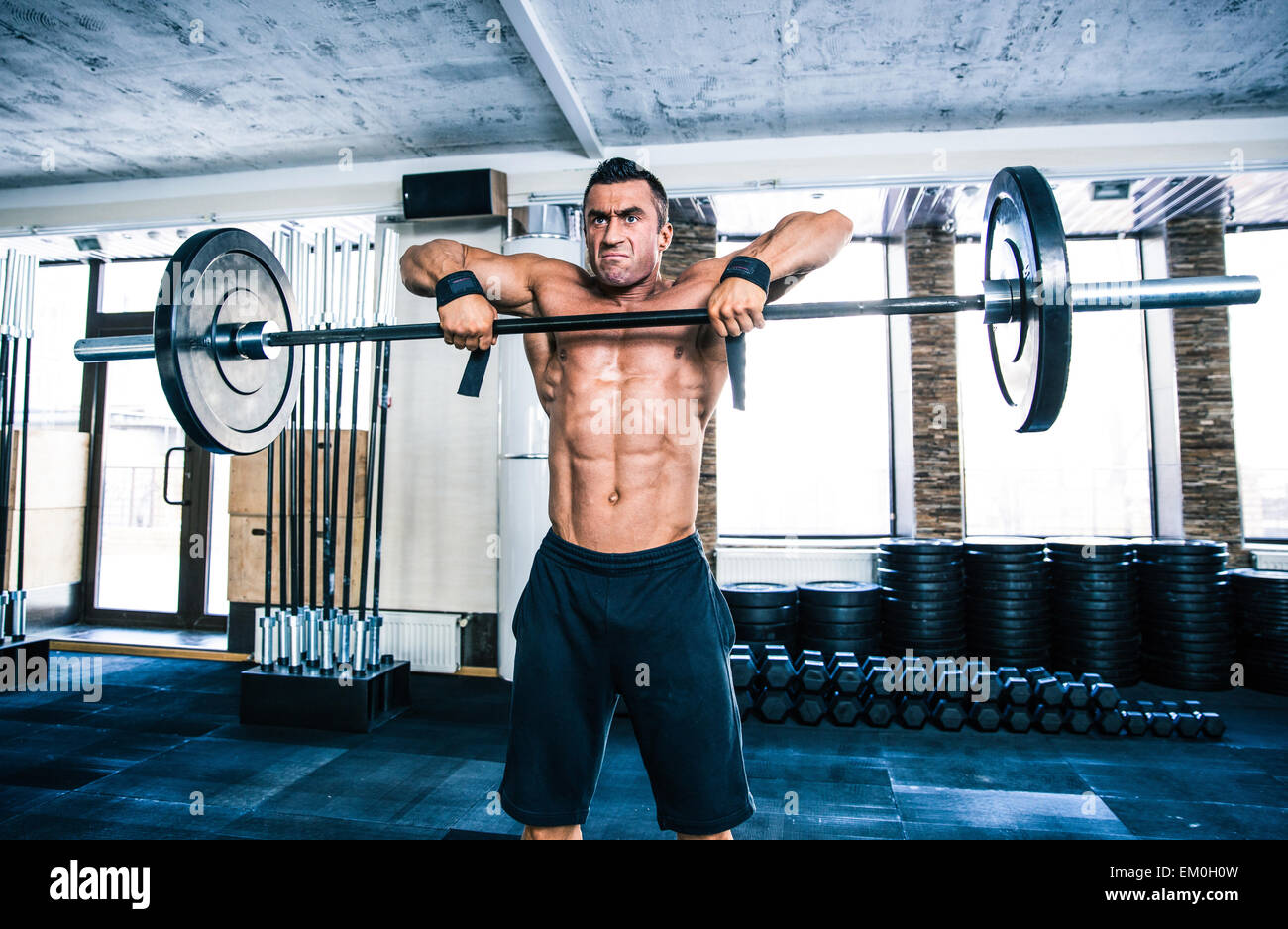 Handsome fitness man lifting barbell at gym Stock Photo - Alamy