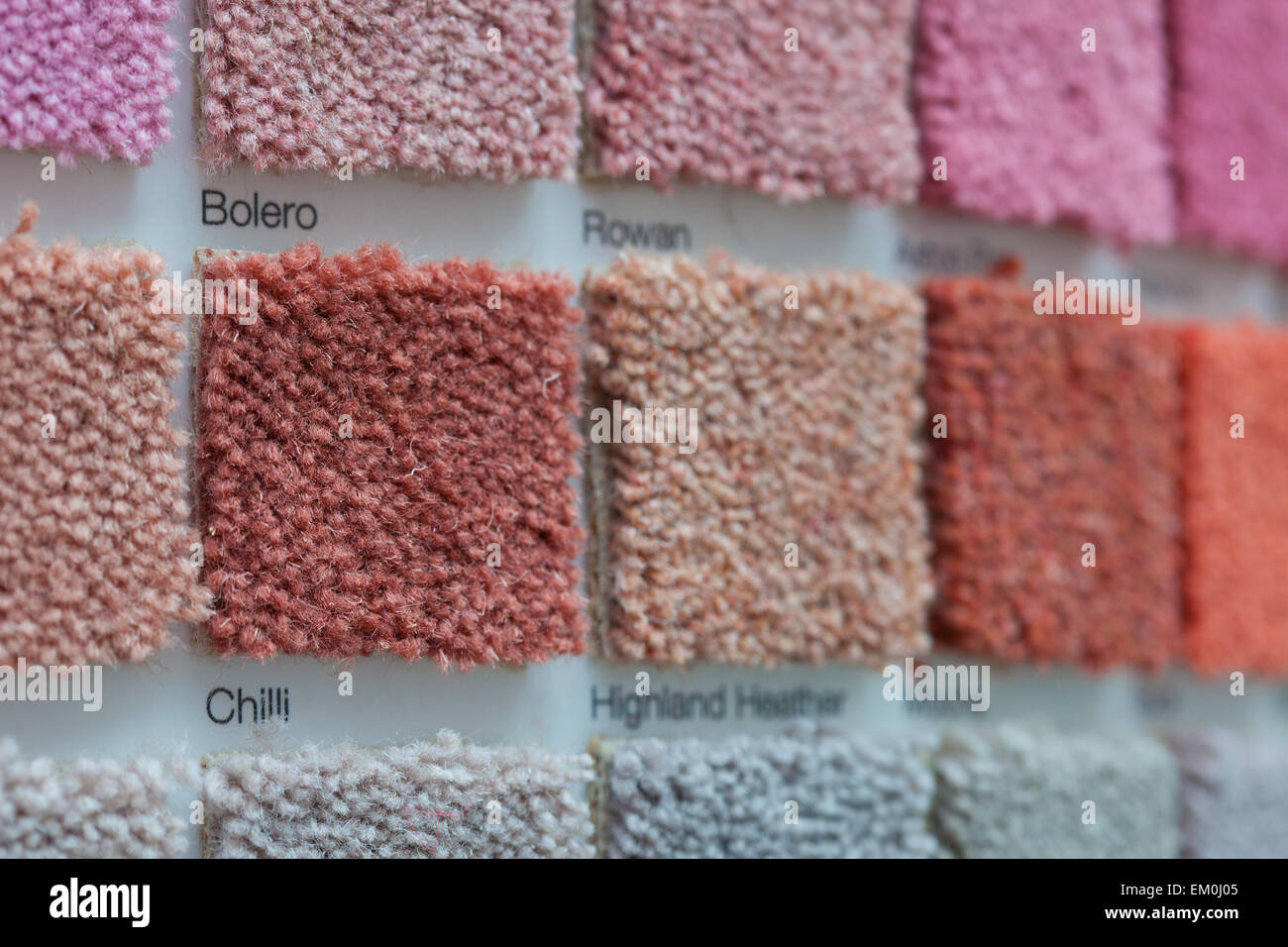 Carpet samples in shades of red, orange and pink Stock Photo - Alamy
