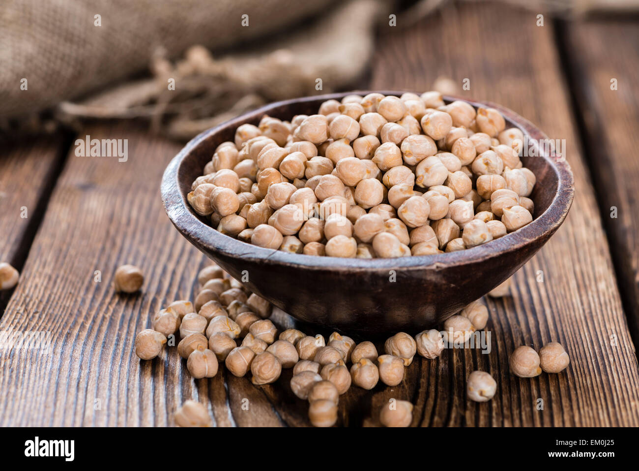 Portion of Chick Peas (close-up shot) on wooden background Stock Photo ...