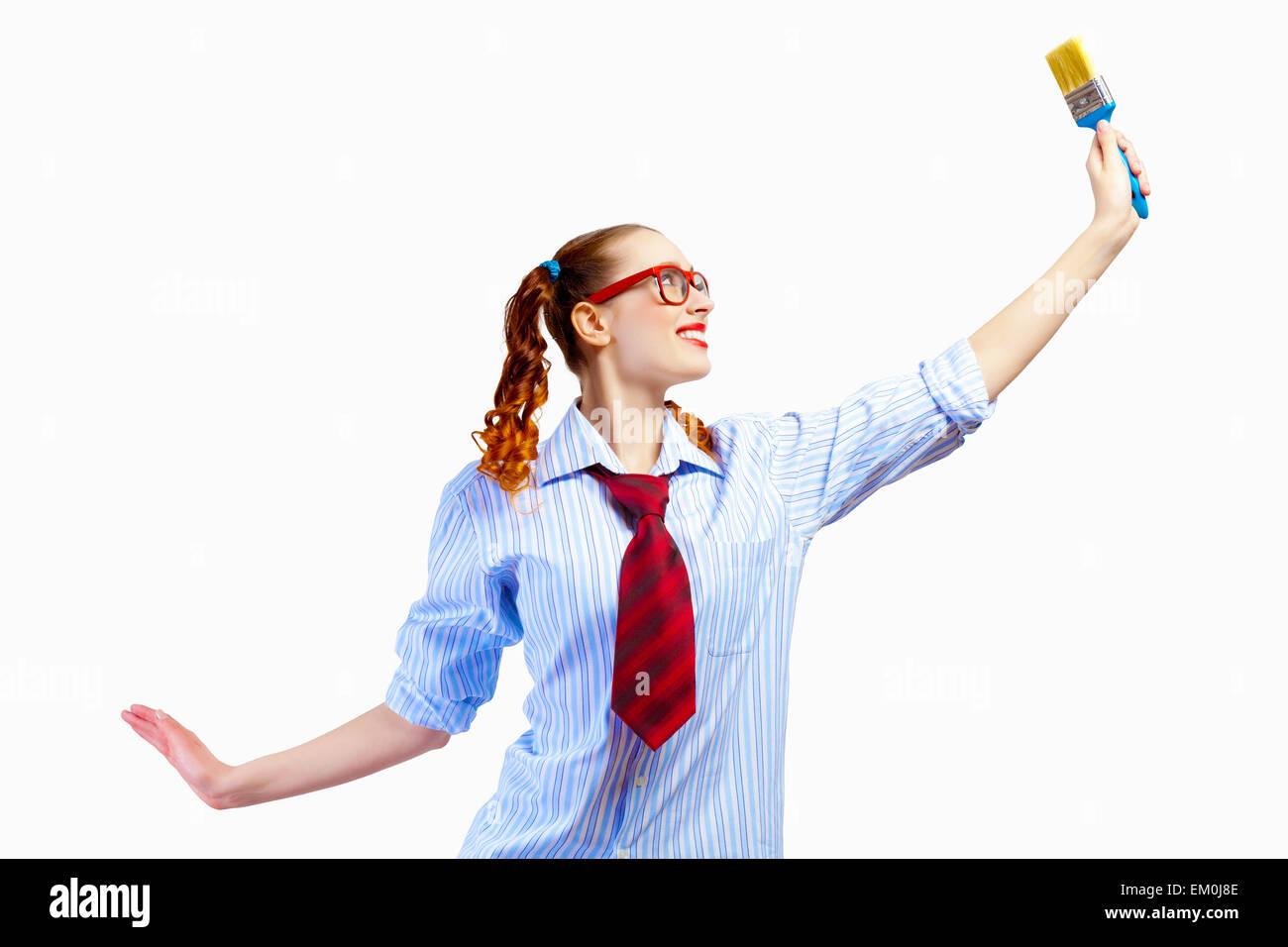Teenager girl holding paintbrush Stock Photo - Alamy