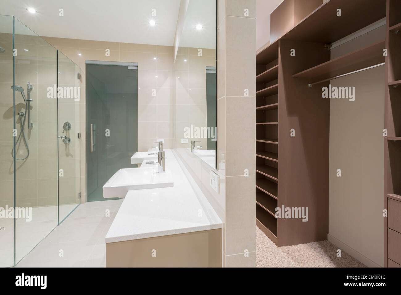 Spacious contemporary bathroom with shower and walk in robe Stock Photo ...