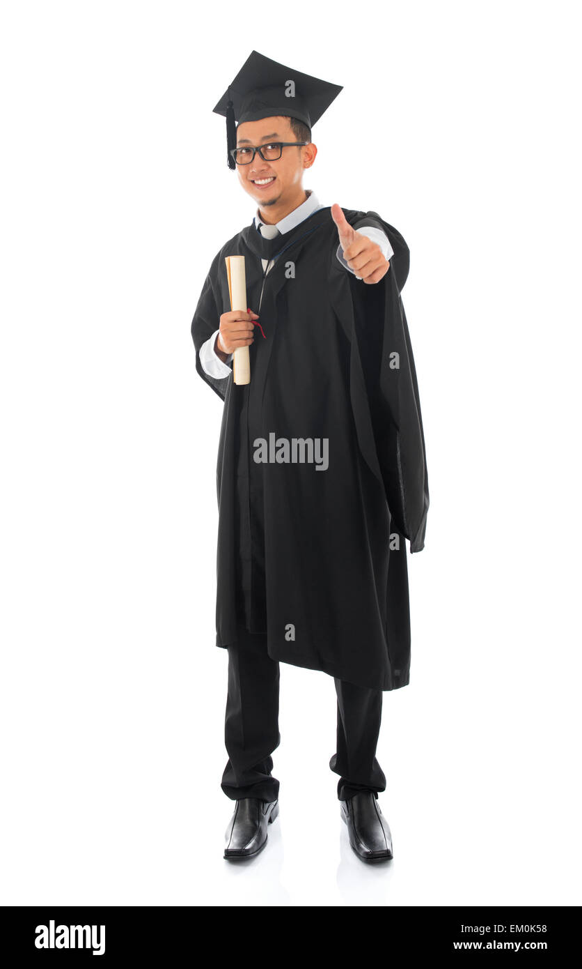 Asian male university student in graduation gown thumb up Stock Photo ...