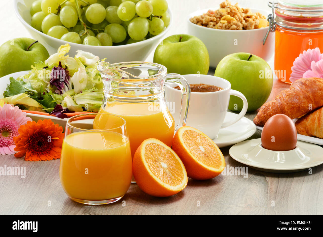 Breakfast consisting of fruits, orange juice, coffee, honey, bread and ...