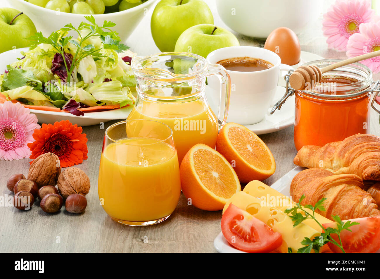 Breakfast consisting of fruits, orange juice, coffee, honey, bread and ...