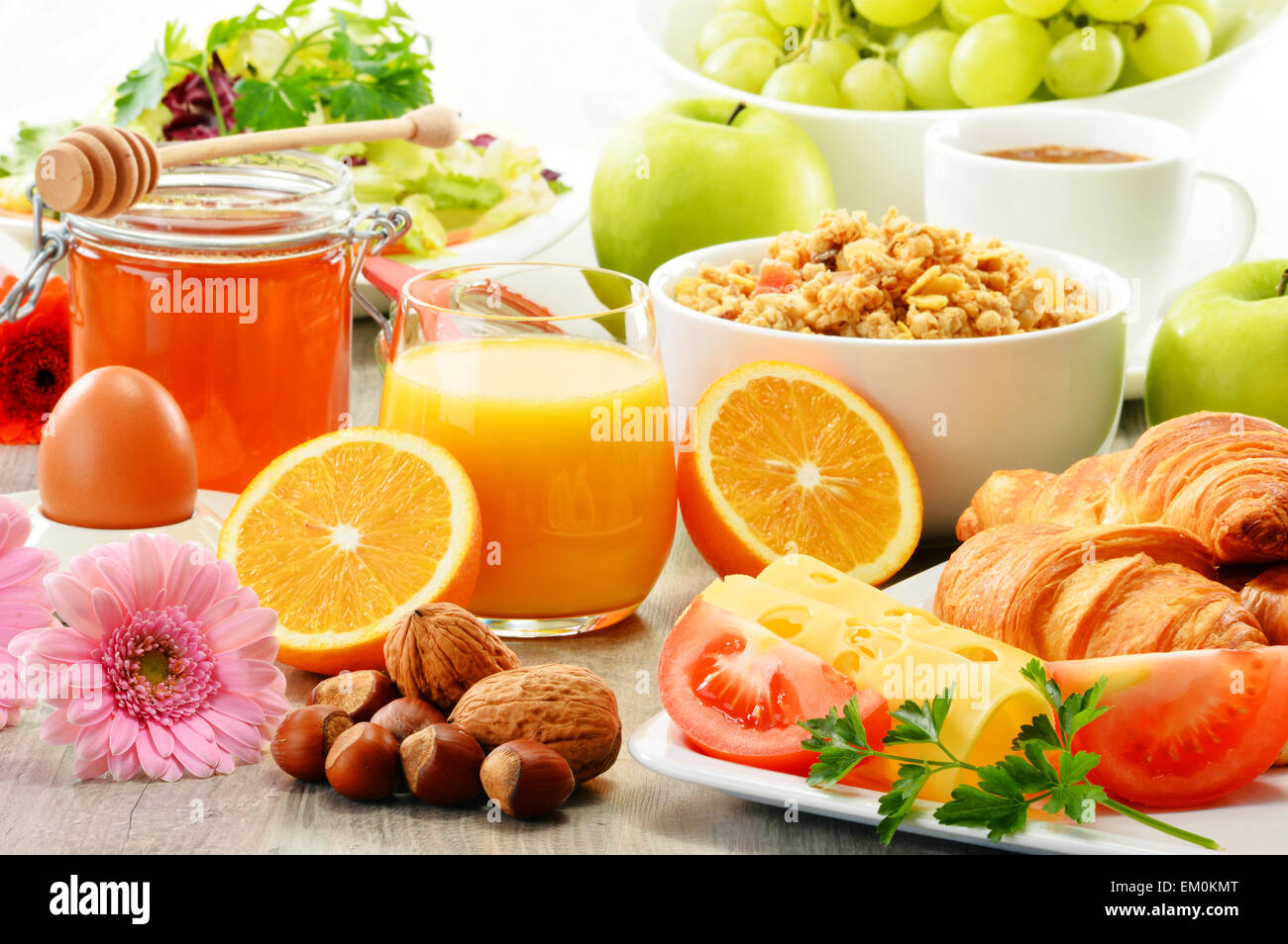 Breakfast consisting of fruits, orange juice, coffee, honey, bread and ...