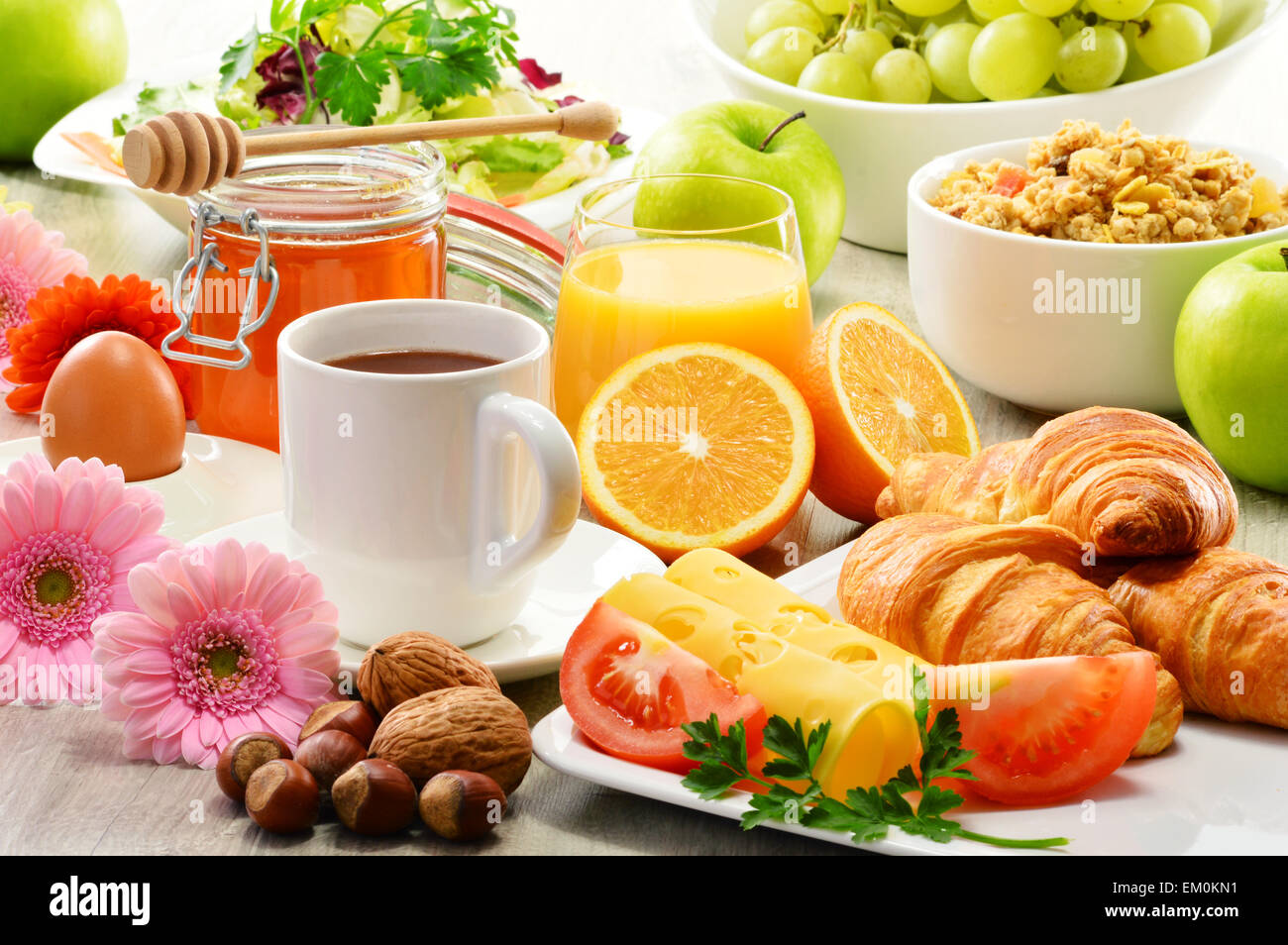 Breakfast consisting of fruits, orange juice, coffee, honey, bread and ...