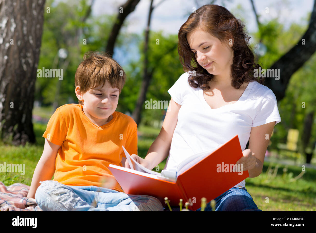 reading a book together Stock Photo - Alamy