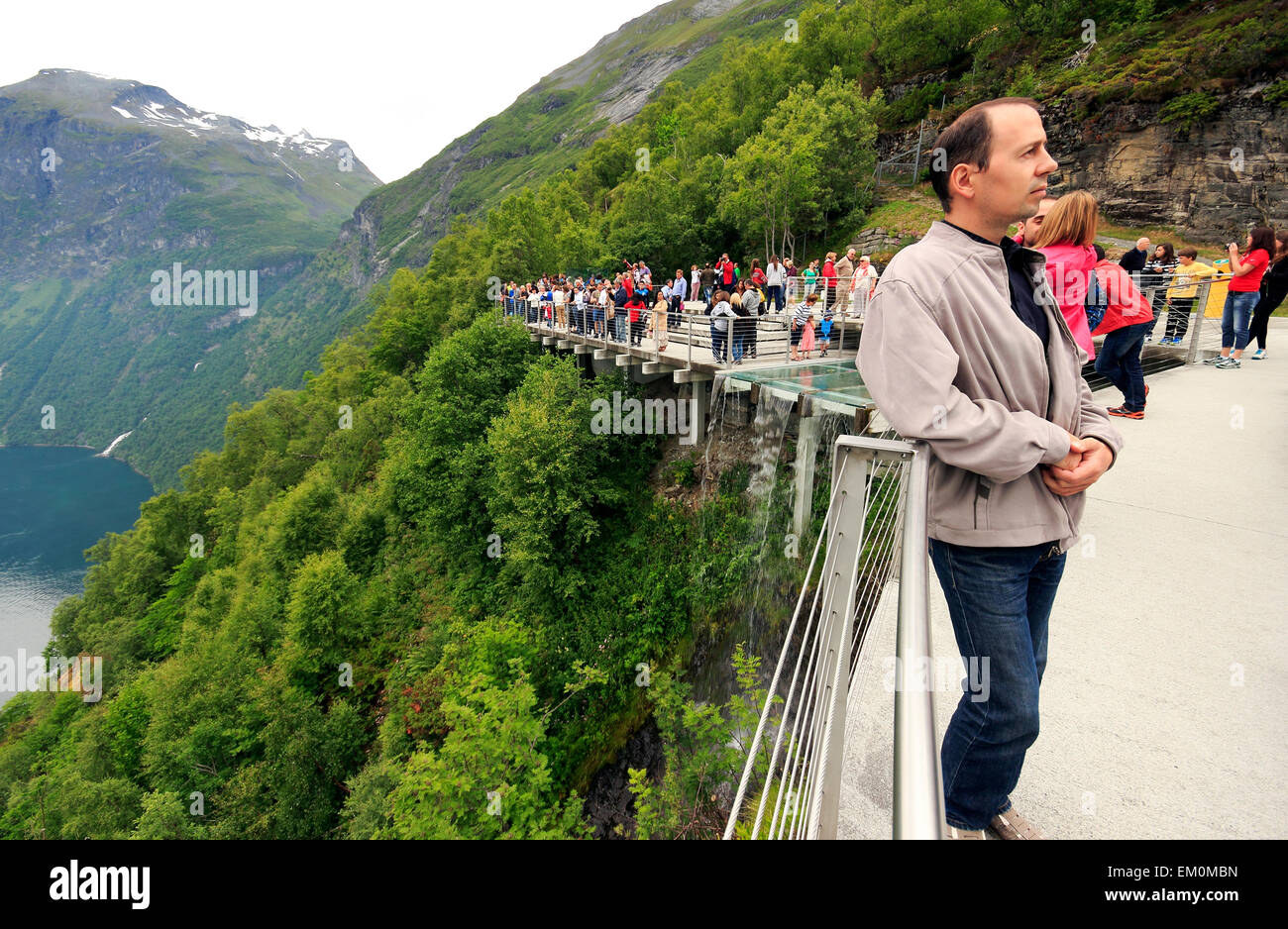 Man standing at a scenic viewpoint, tourists at the Eagle’s Road ... Man standing at a scenic viewpoint, tourists at the Eagle’s Road ...