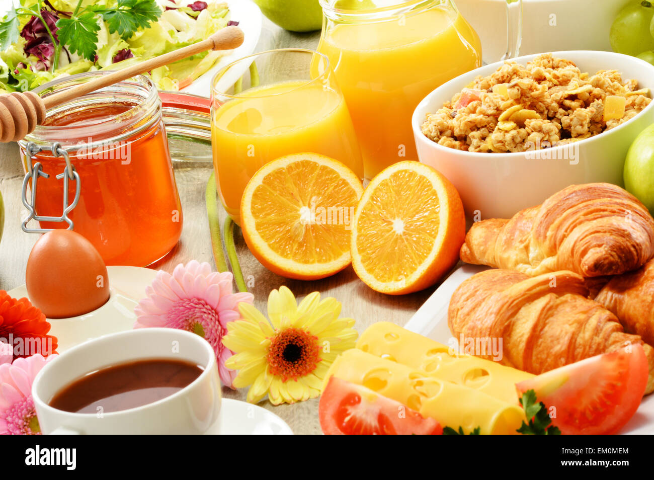 Breakfast consisting of fruits, orange juice, coffee, honey, bread and ...