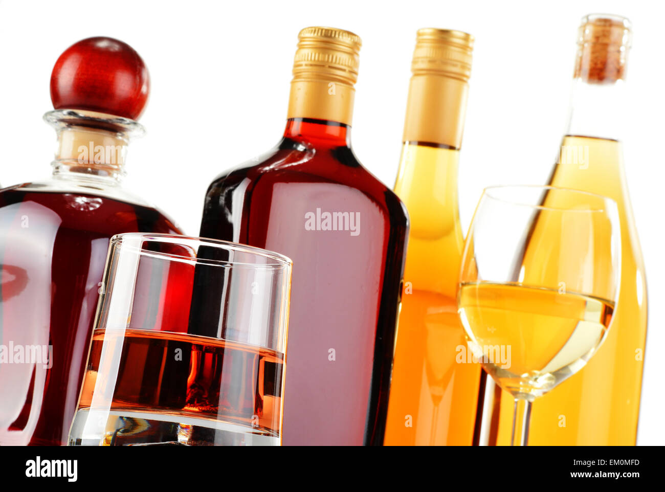 Bottles and glasses of assorted alcoholic beverages isolated on white ...